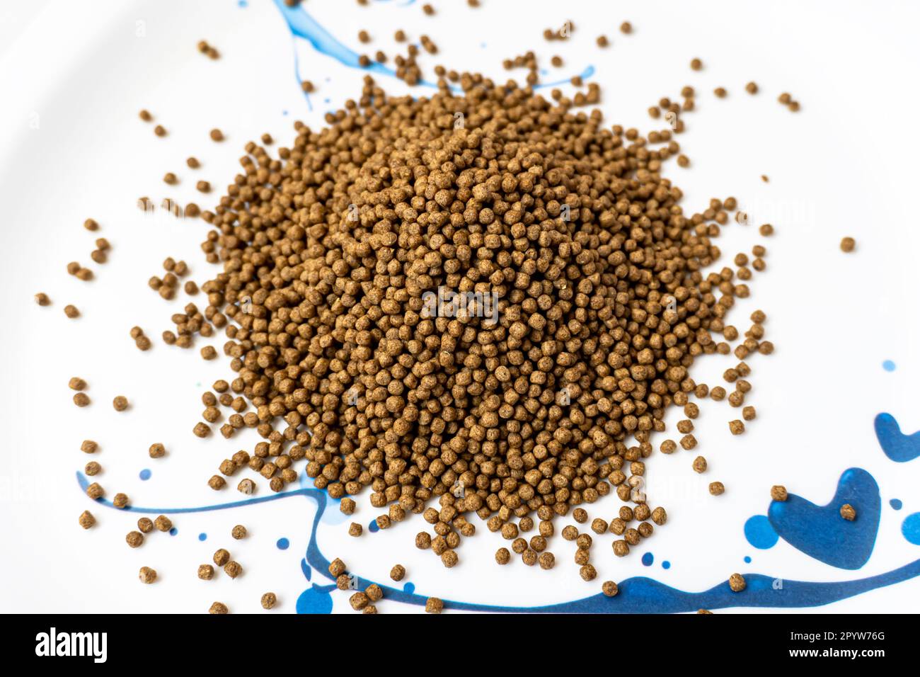 Animal feed for all kind of fish closeup with white background. The ...