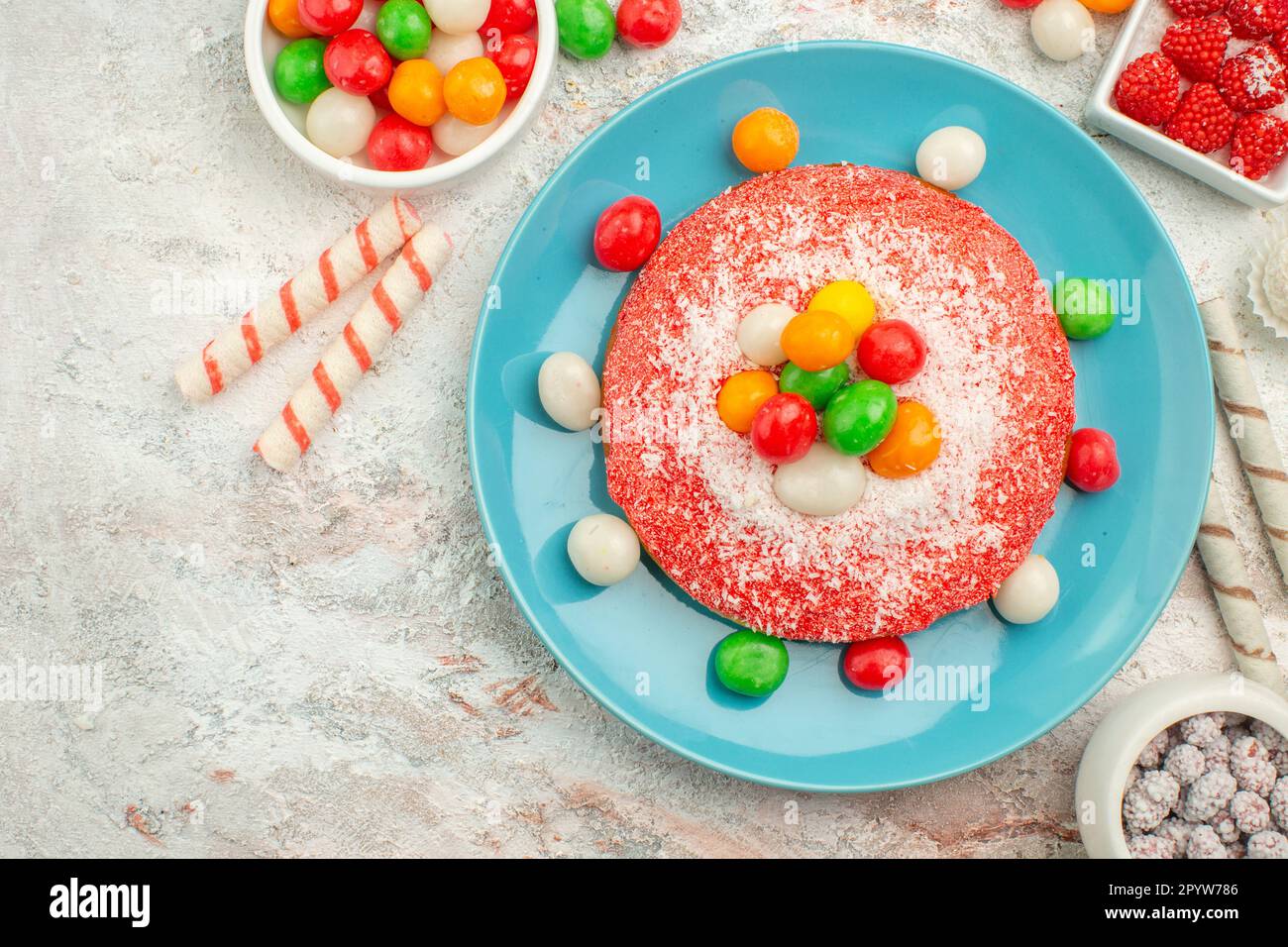 top view delicious pink cake with colorful candies on white floor candy ...