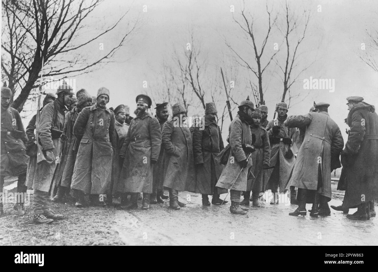 German soldiers guarding Russian prisoners during the winter of 1915 on ...