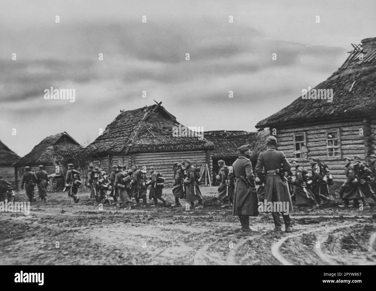 Officers and a column of German soldiers in a Russian village. Photo ...