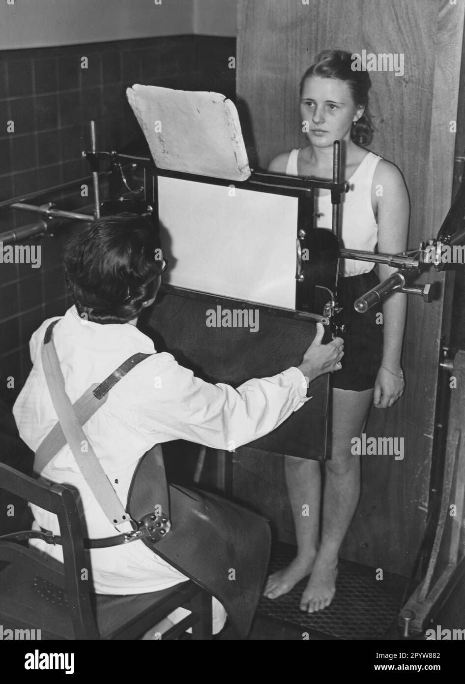 A young woman undergoing a fitness examination for service in the ...