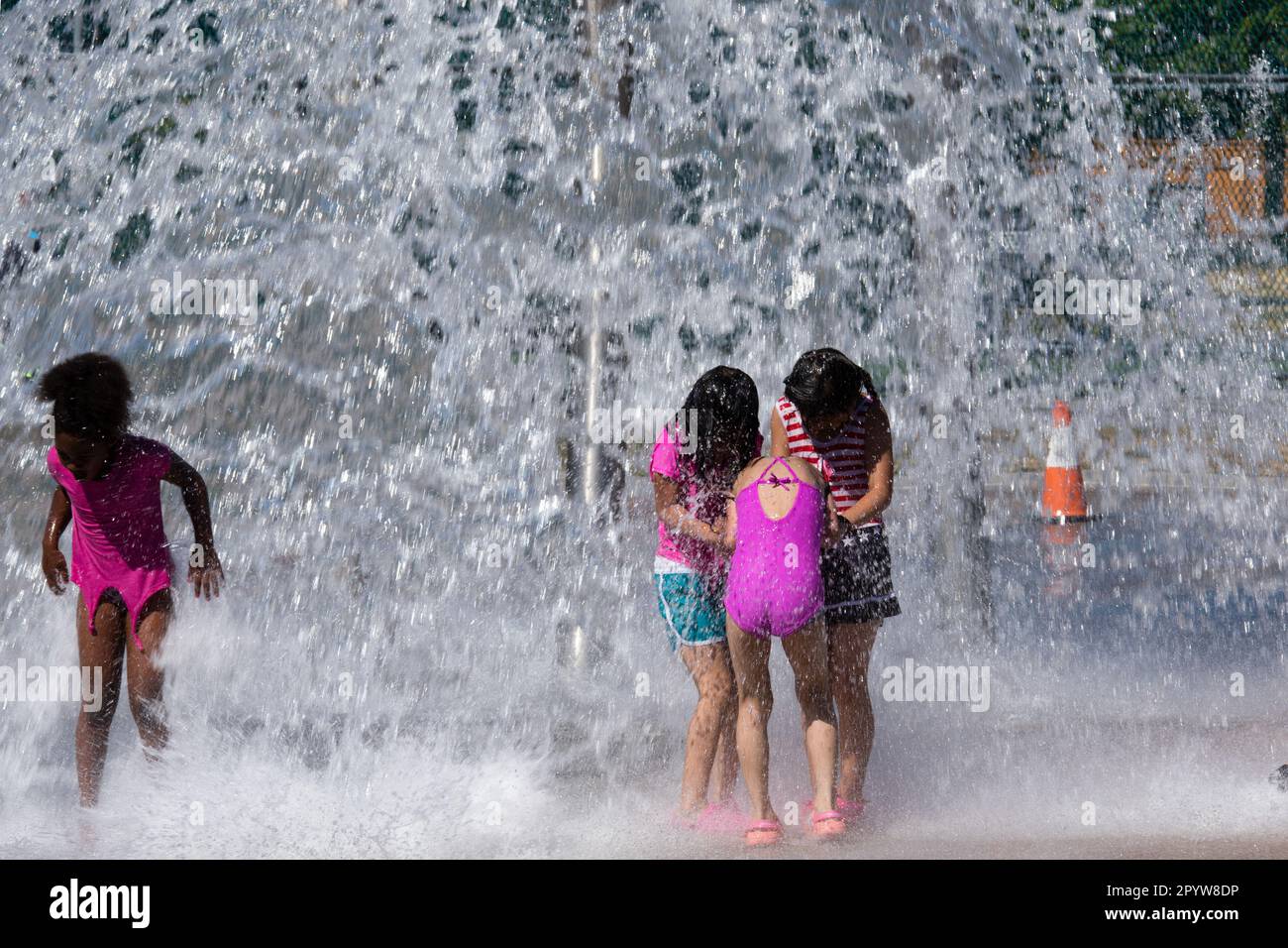 Kids play with water in a park under Heat warning in Vancouver, BC. The ...