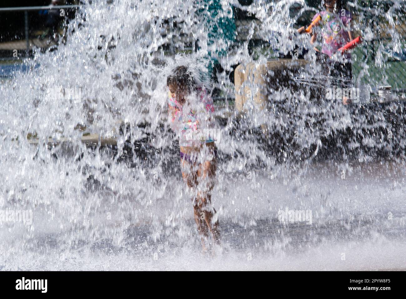 Kids play with water in a park under Heat warning in Vancouver, BC. The ...