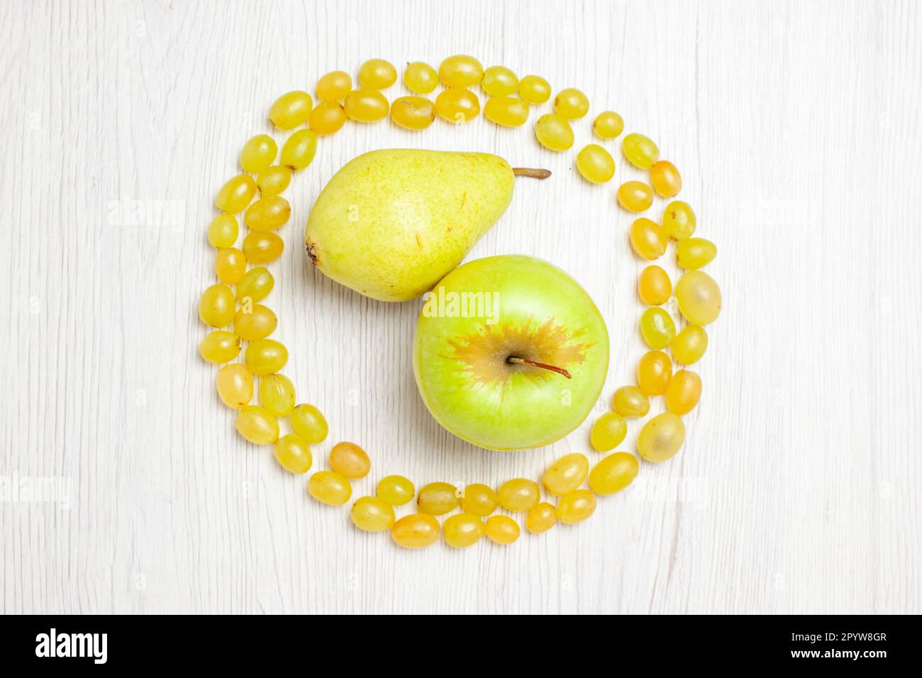top view fresh green grapes with pear and apple on white desk fruit ...