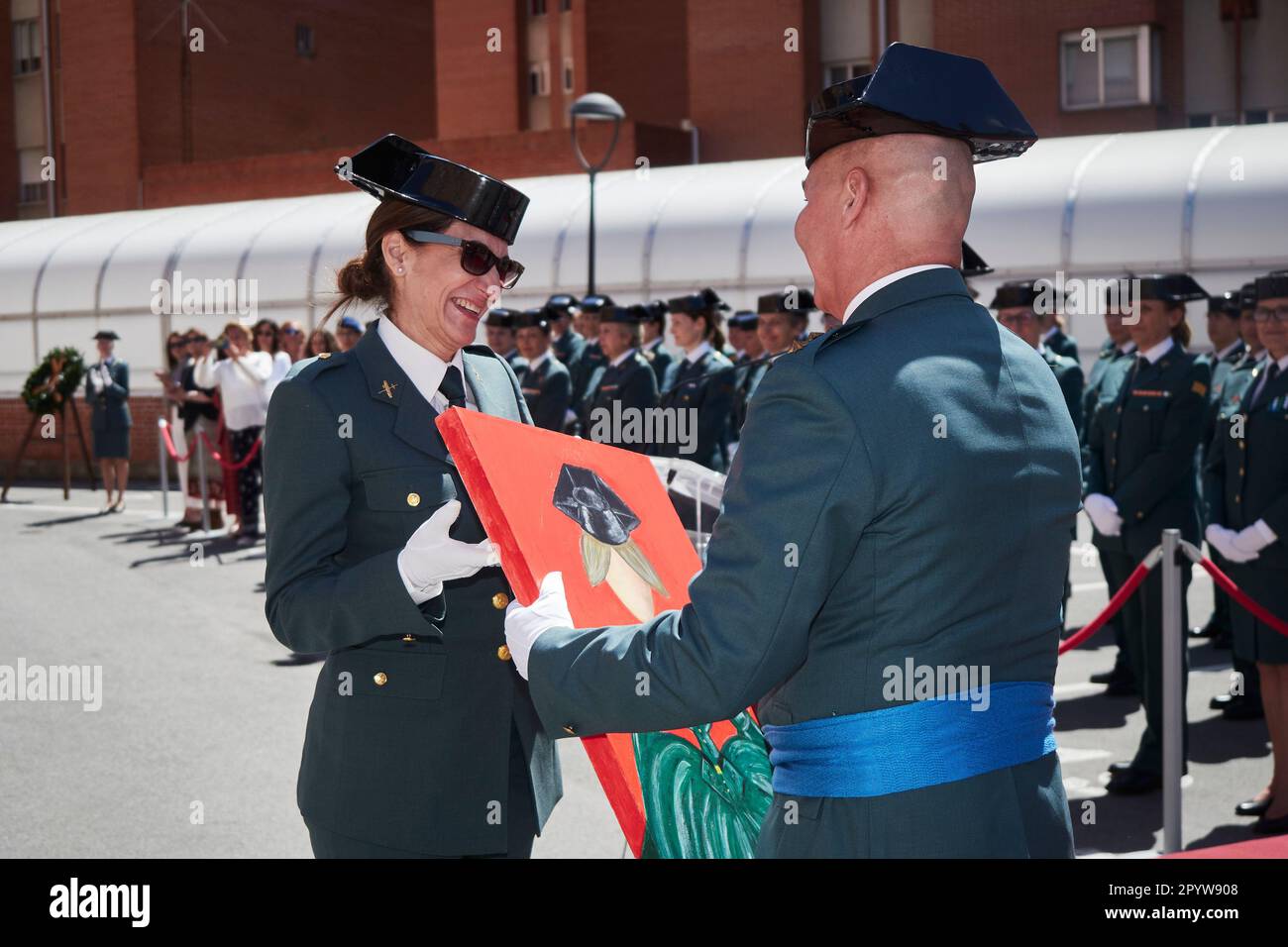 A Guardia Civil officer hands over a painting of a "menina" dressed as ...