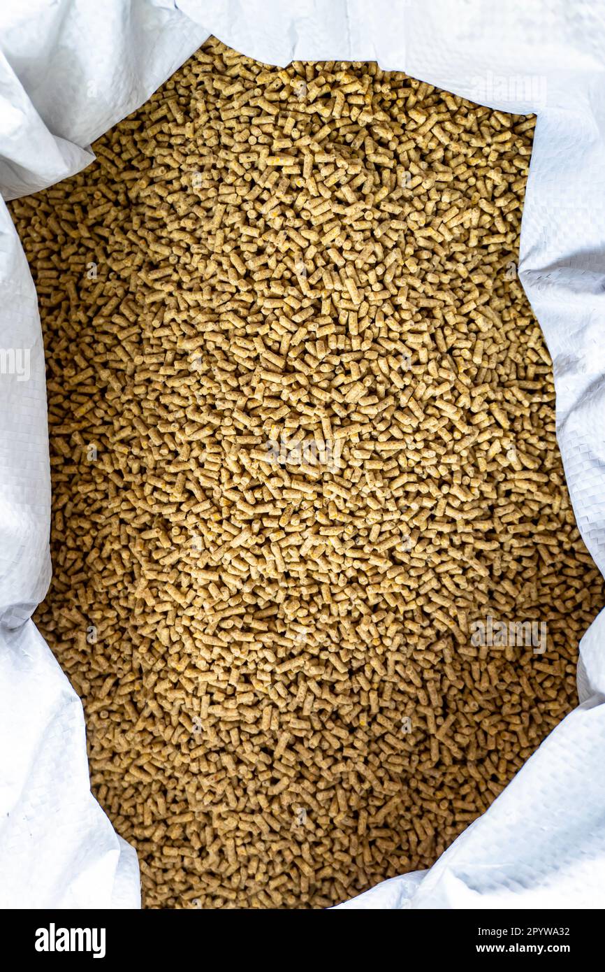 A white bag of granulated chicken feed isolated on white background ...