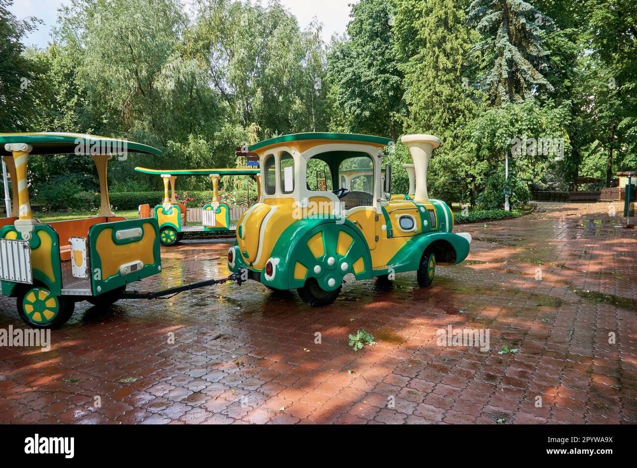 Multi colored children's train for children to ride in a summer ...