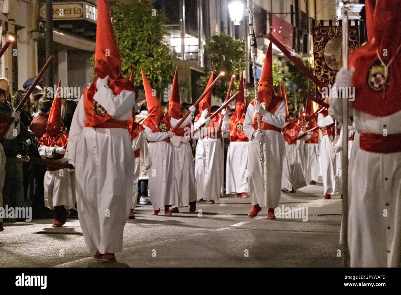 Cofradias wearing red cone shaped hoods walk through the streets during ...