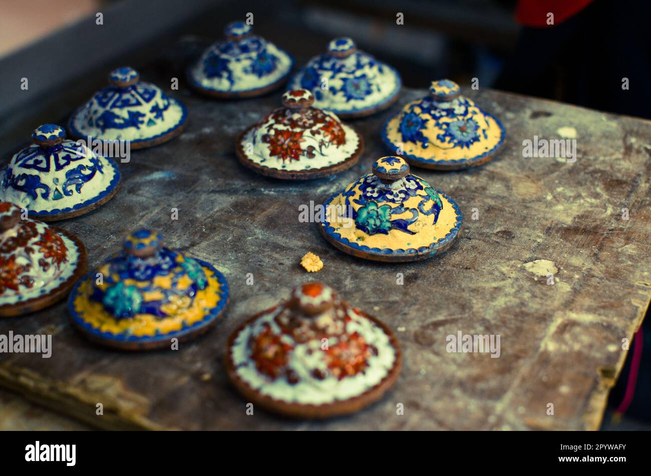 A closeup of ceramic lids painted in vibrant colors Stock Photo - Alamy