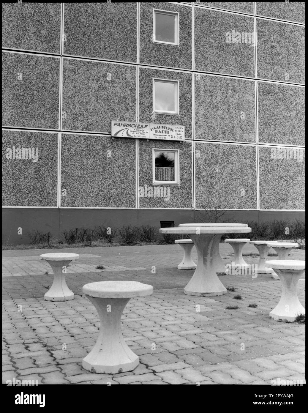 Rest Area Stools And Tables Made Of Concrete In Front Of A Prefabricated Building From The