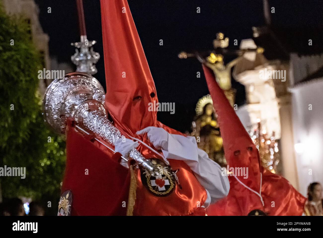 Cofradias wearing red cone shaped hoods walk through the streets during ...