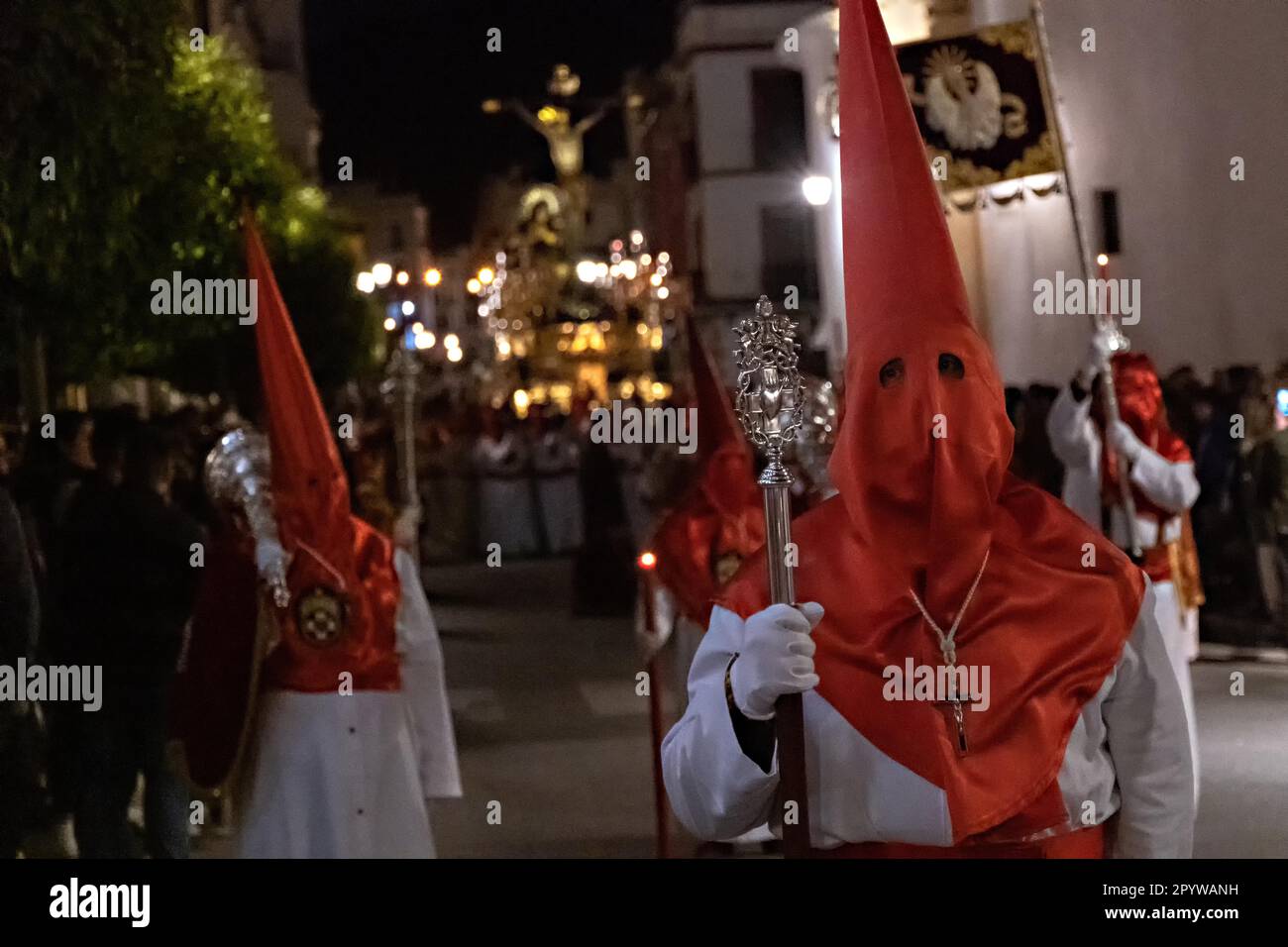 Cofradias wearing red cone shaped hoods walk through the streets during ...