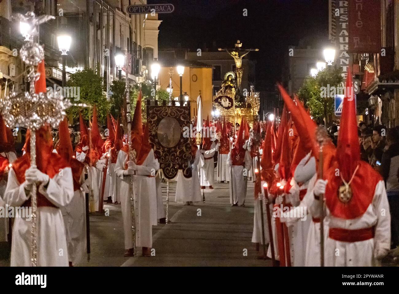 Cofradias wearing red cone shaped hoods walk through the streets during ...