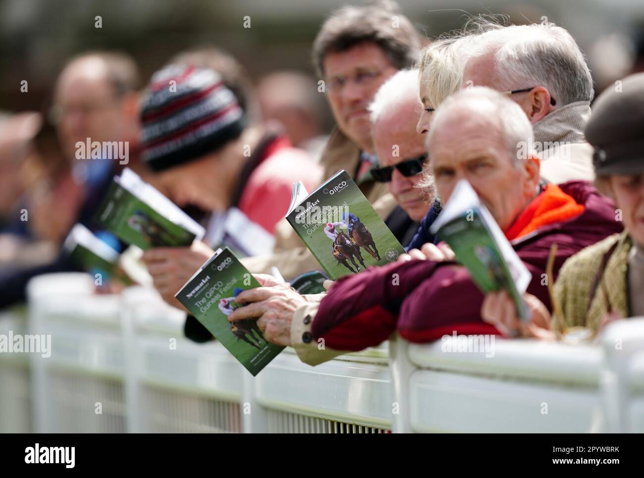 Racegoers check the form on day one of The QIPCO Guineas Festival at ...