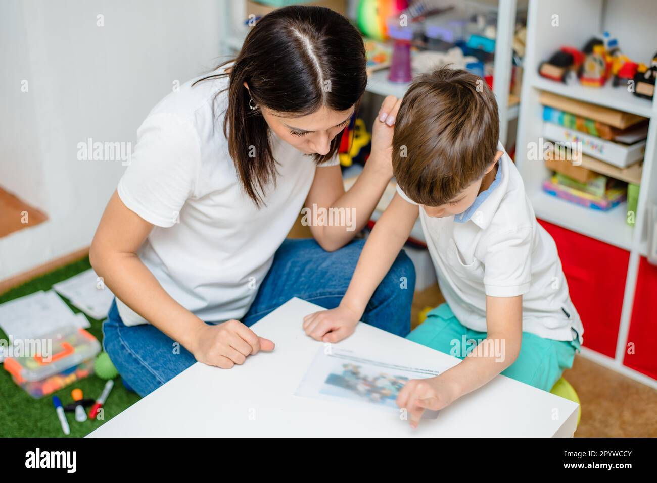 Cute woman speech therapist teaches child to pronounce words sounds and ...