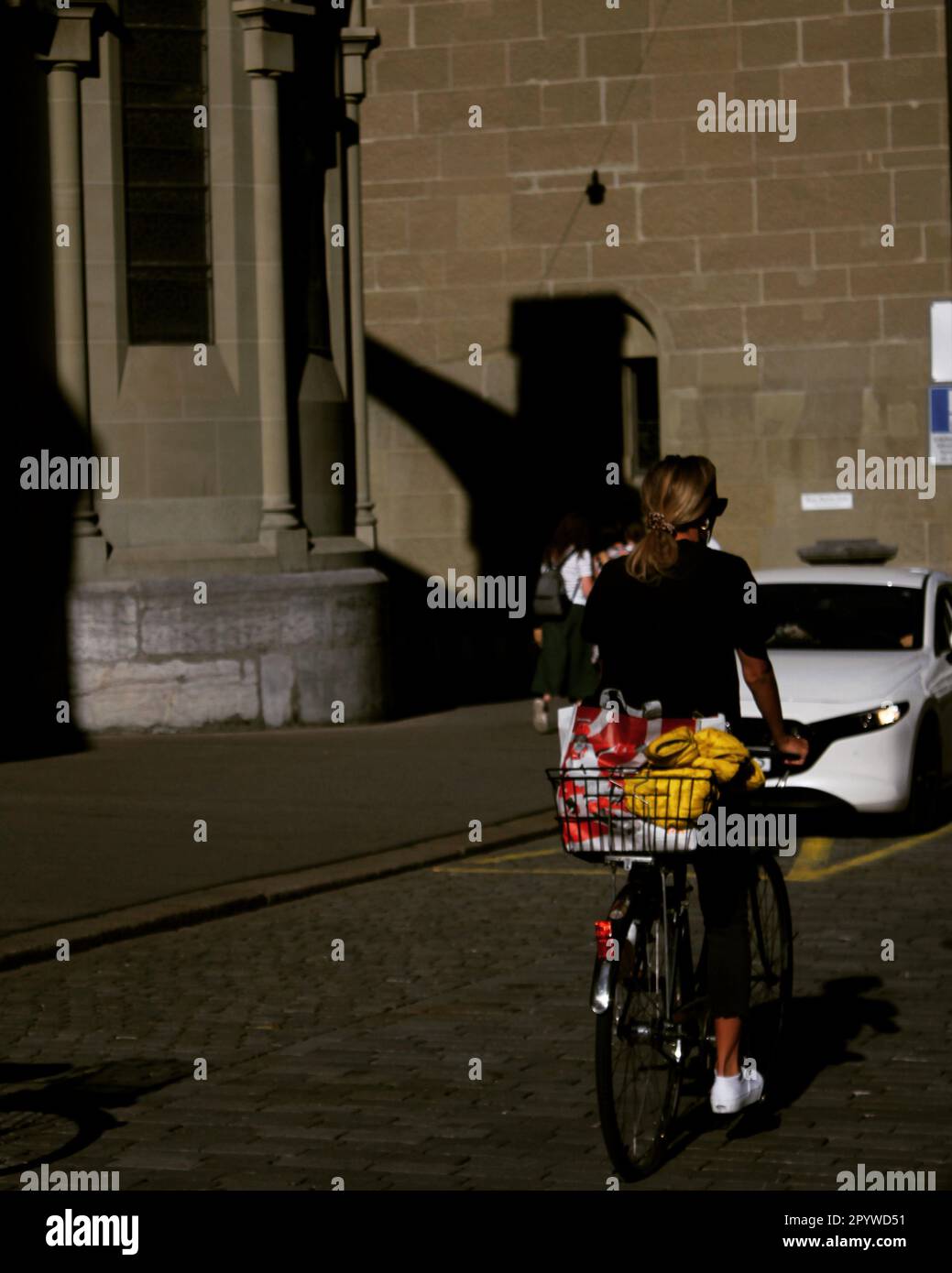 A woman riding bicycle in the streets of Bern, Switzerland Stock Photo ...