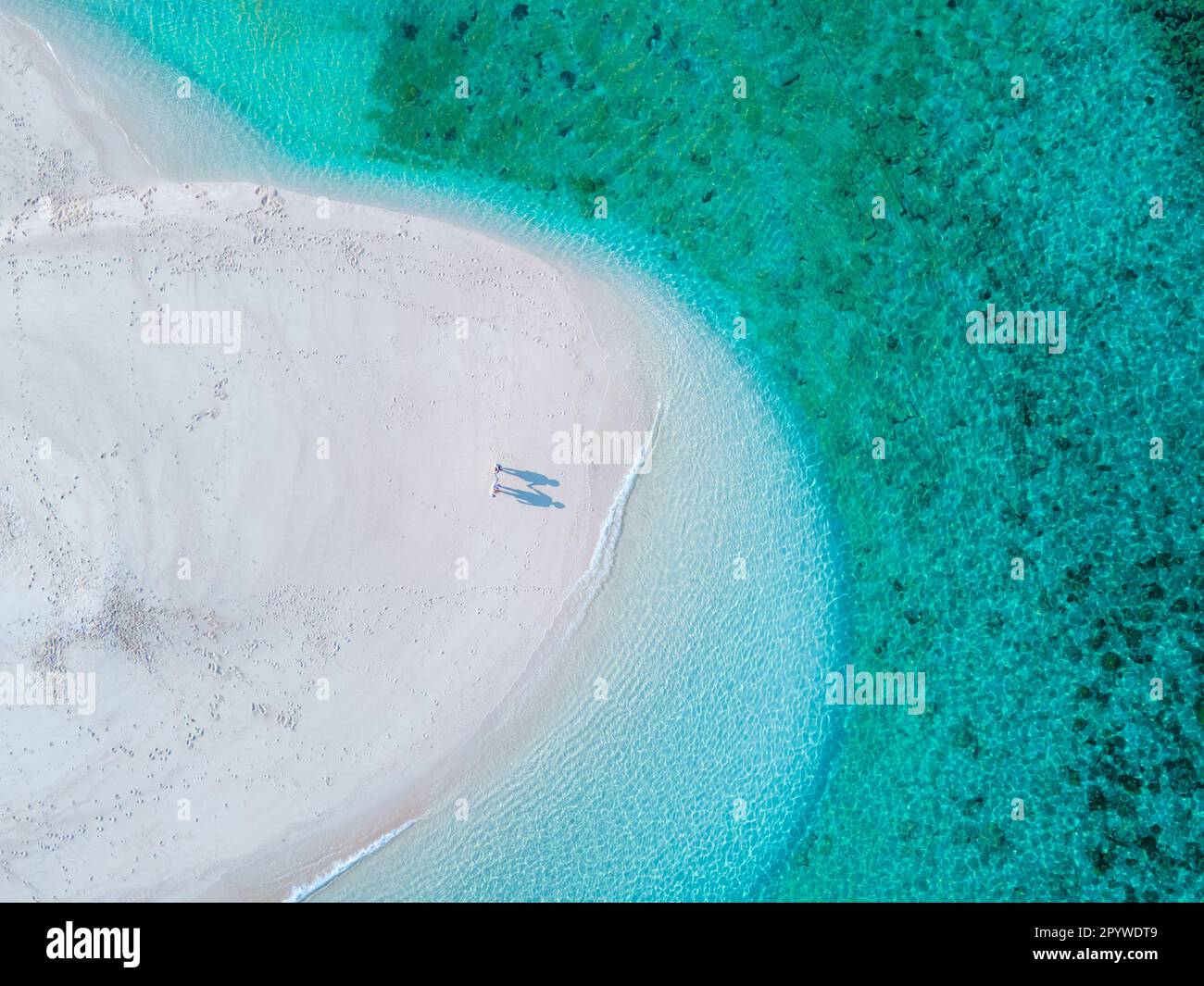 men and women walking on a sandbar in the ocean of Koh Lipe Southern Thailand during vacation. a ...