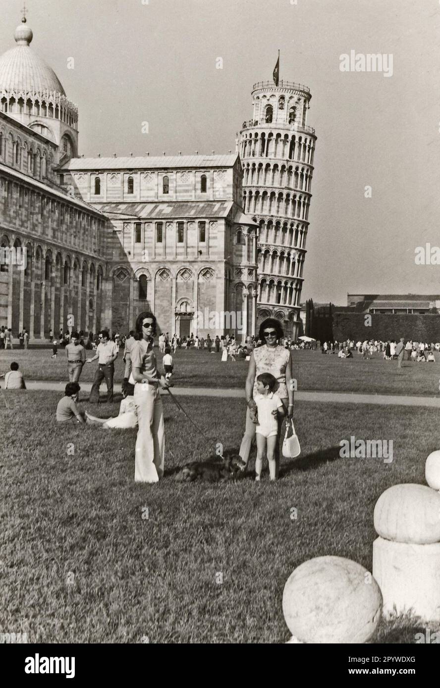 Family vacation at the Leaning Tower of Pisa in Italy. [automated ...