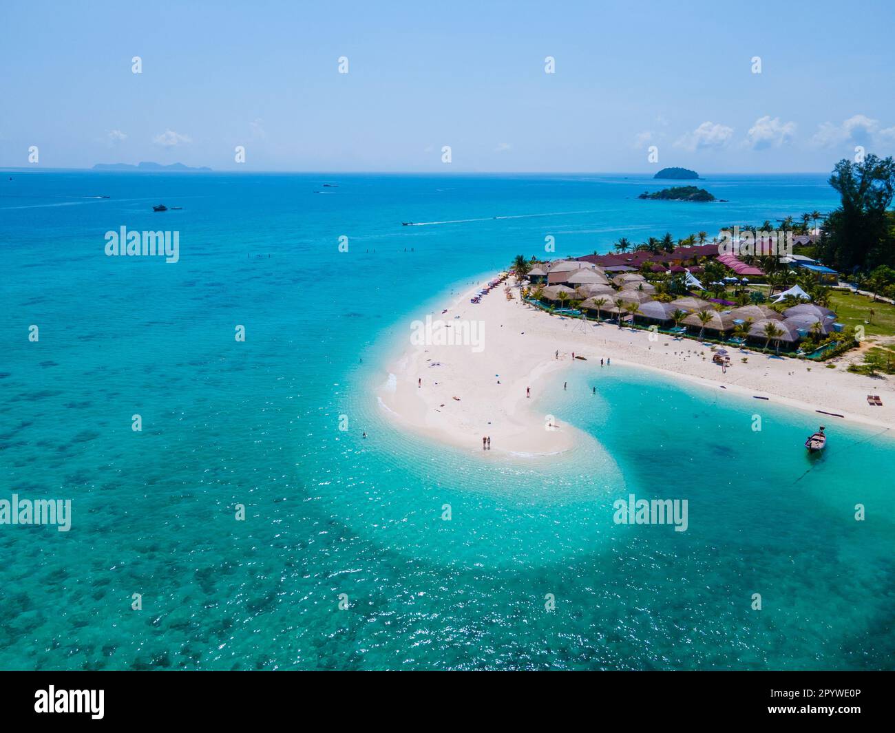 men and women walking on a sandbar in the ocean of Koh Lipe Southern ...