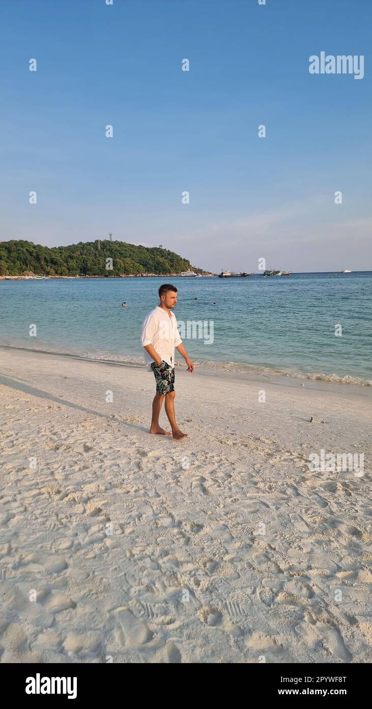 men walking on a sandbar in the ocean of Koh Lipe Southern Thailand ...