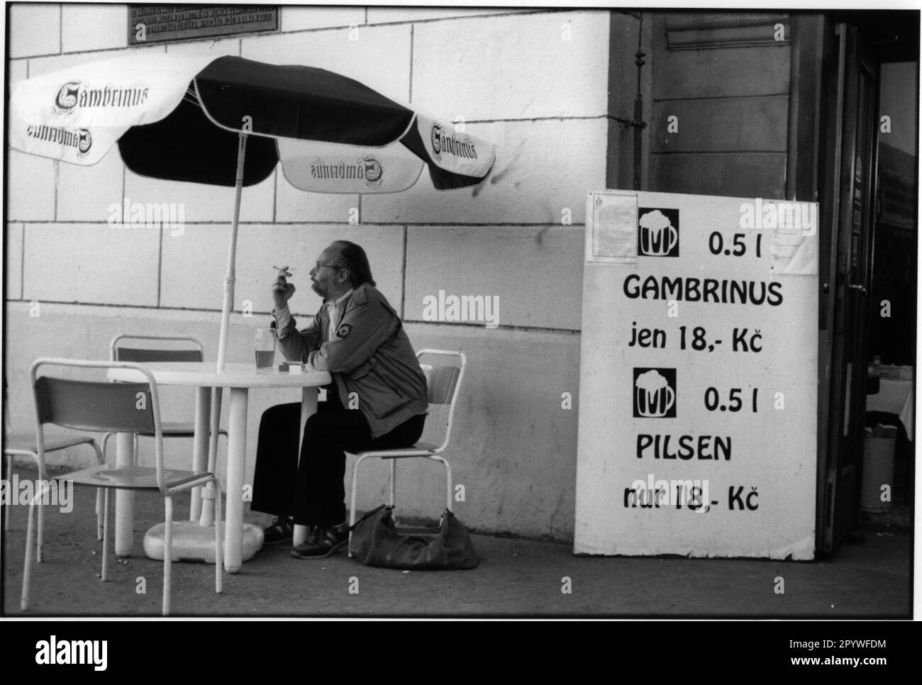 Man sits table glass Black and White Stock Photos & Images - Alamy
