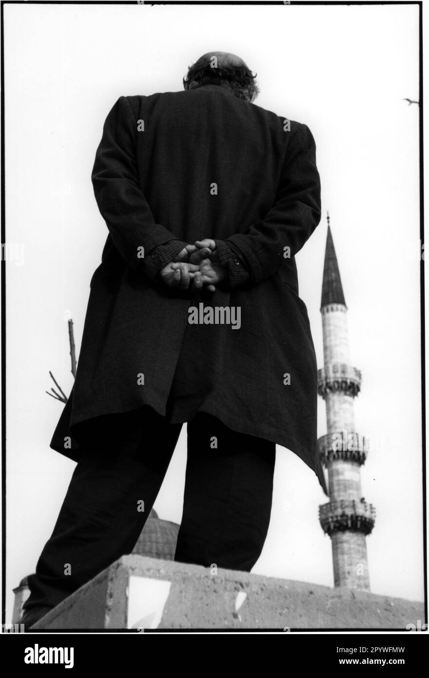 Turkey, Istanbul. Ethnology. Man with a coat from behind, with the ...