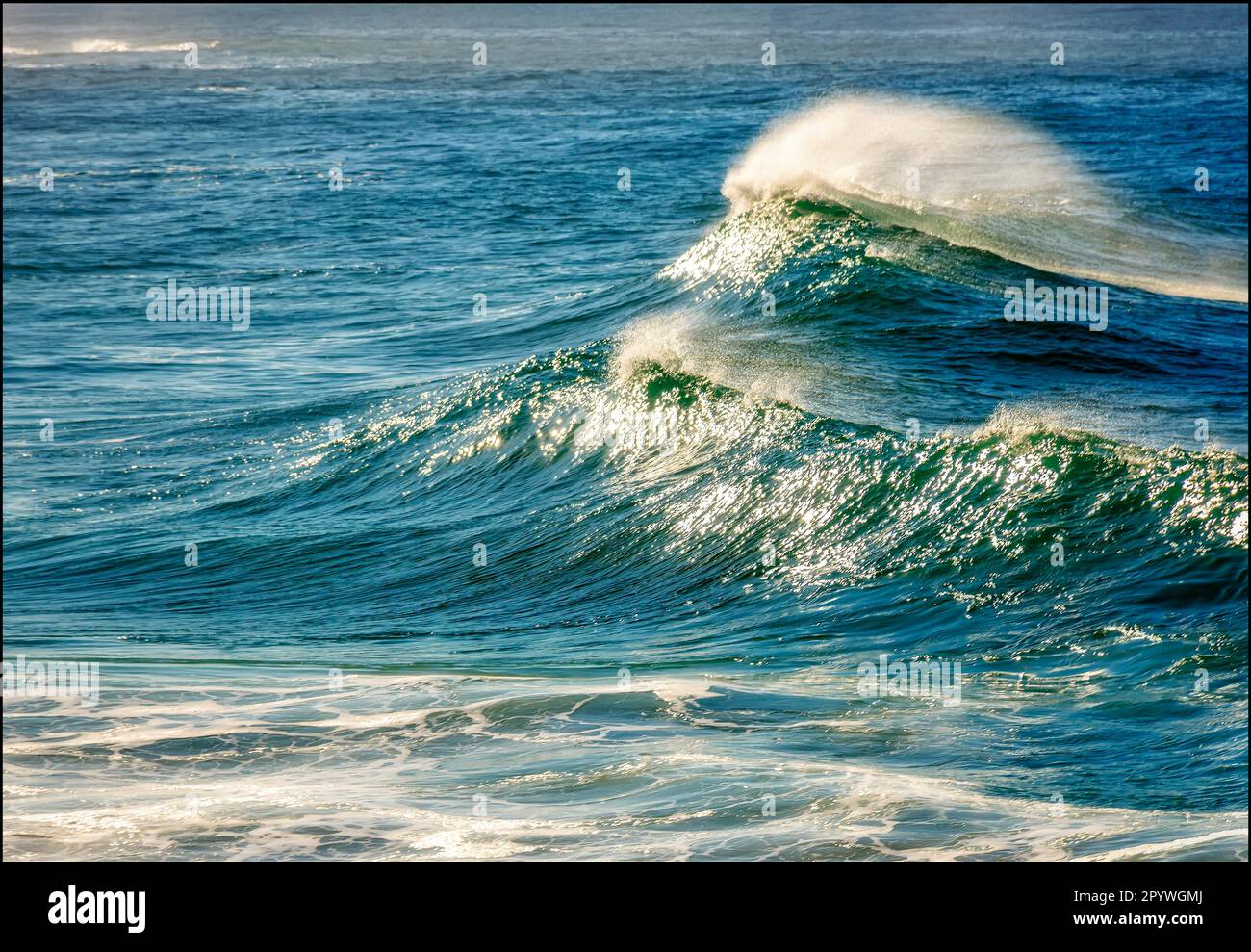 Wave breaking at dawn with sun reflections on the water at Ipanema ...