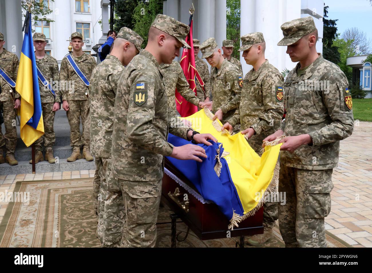 KYIV, UKRAINE - MAY 5, 2023 - Soldiers cover the coffin with the body of US citizen Christopher ...