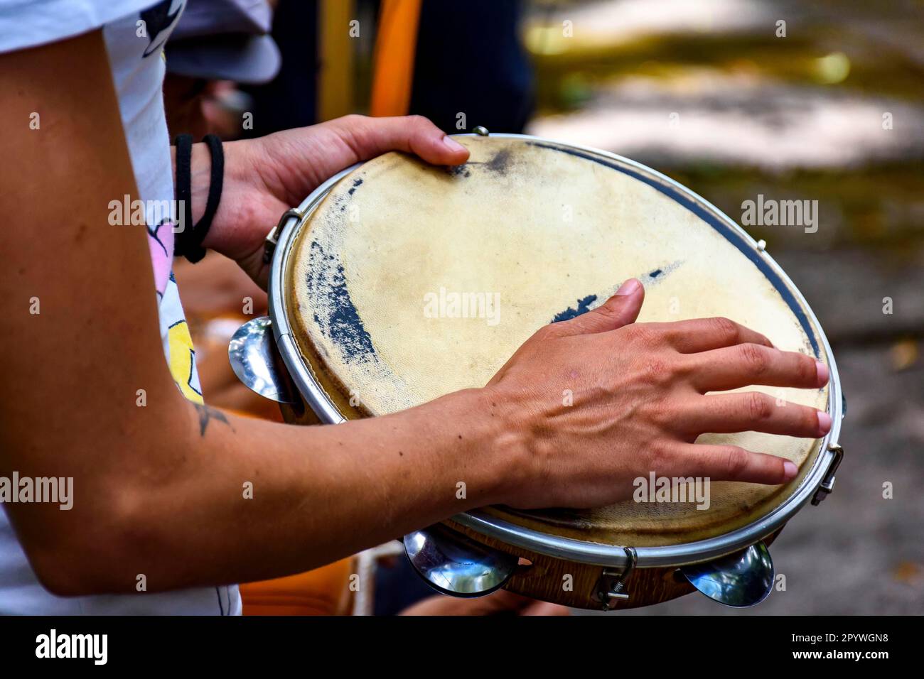 Detail of musician playing tambourine during a samba performance at ...