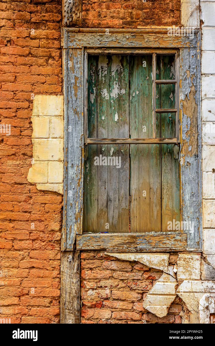 Old wooden window ruined by time on the facade of abandoned house in ...