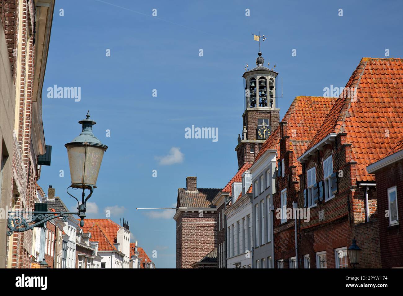 Historical houses facades and the clock tower of the Stadhuis (Town ...