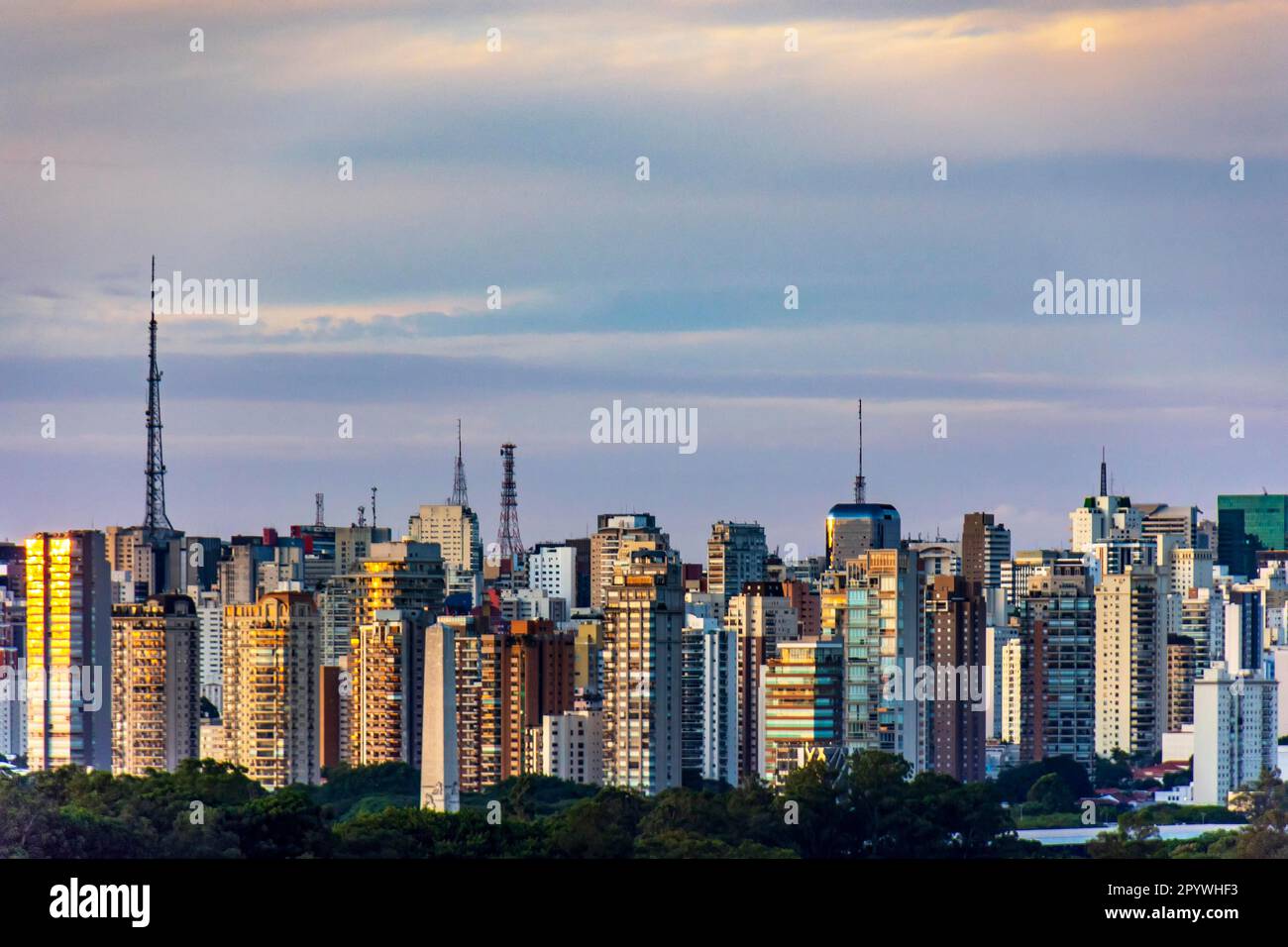 Wall of buildings, towers and communication antennas at dusk in the ...