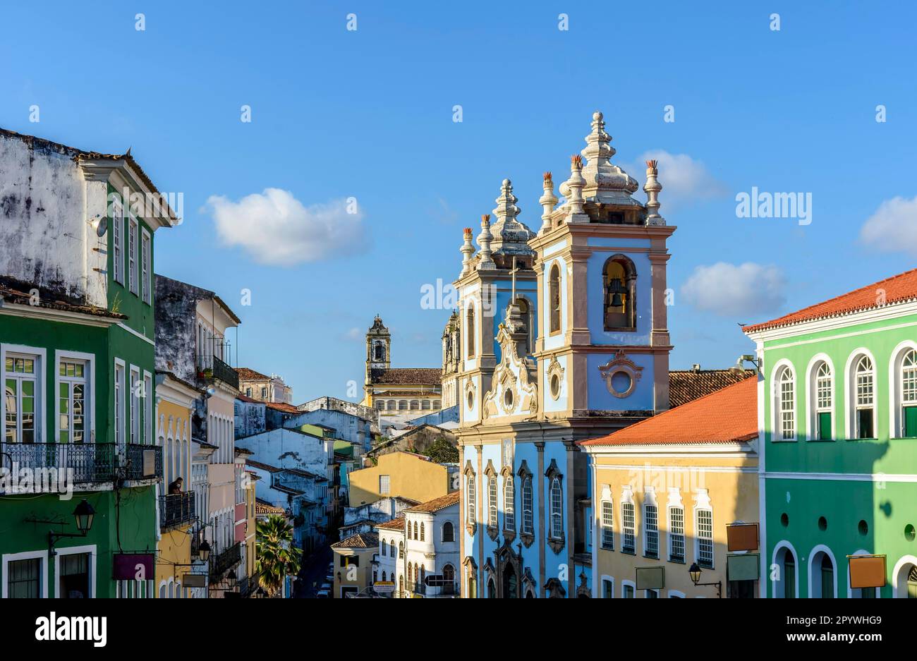 Colorful and ancient colonial houses facades and historic church towers ...