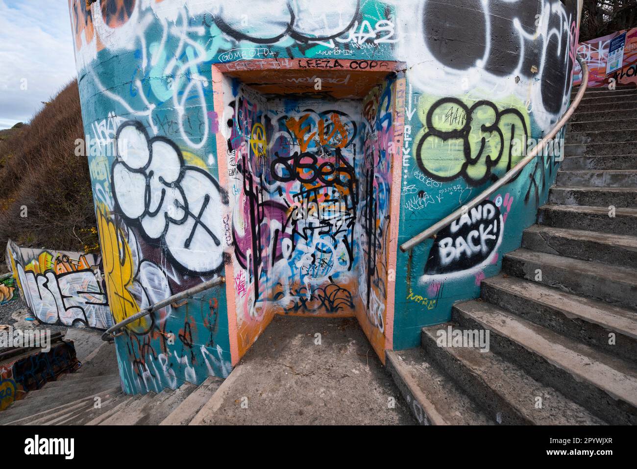 A concrete structure for accessing the beach near Beacon Hill Park, Vicoria Canada is covered in ...
