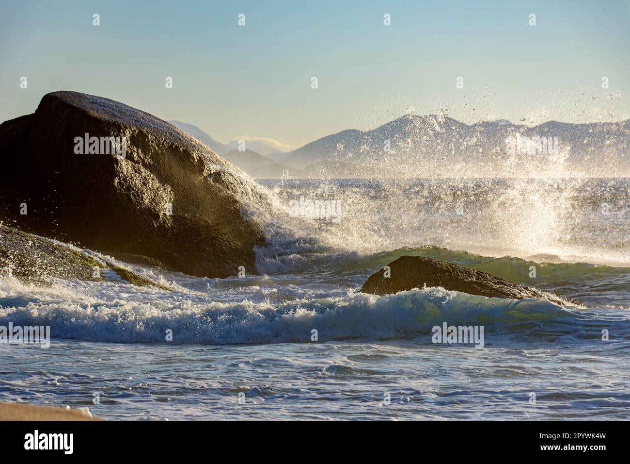 Waves crashing against the rocks at summer dawn on Devil beach in ...