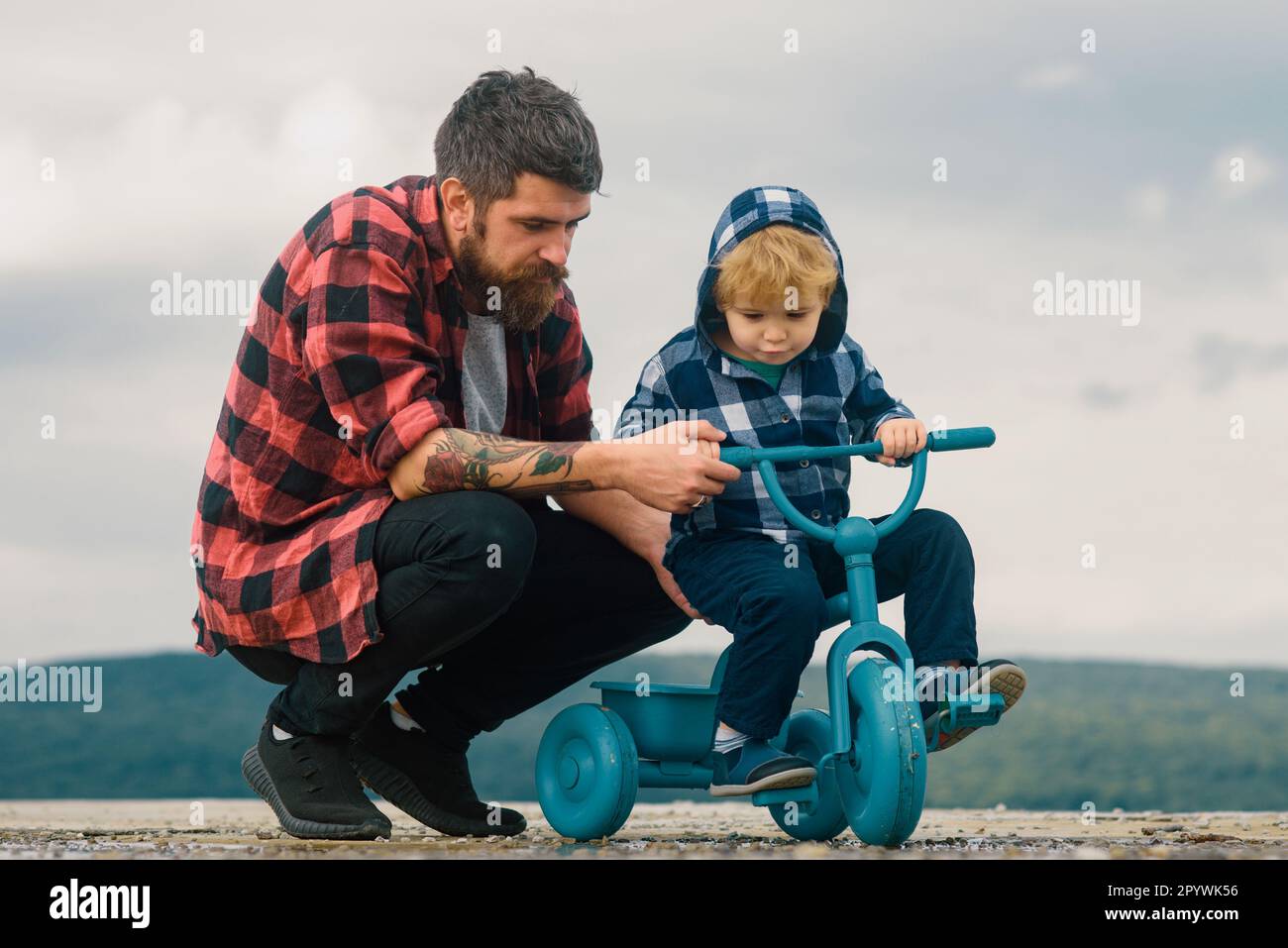Little boy learn to ride a bike with his daddy. Dad teaching son to ...