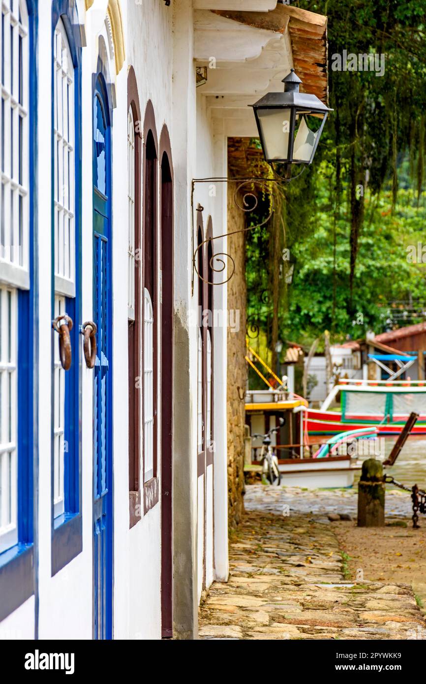 Colonial style house facades with old metal lantern and boats in the ...