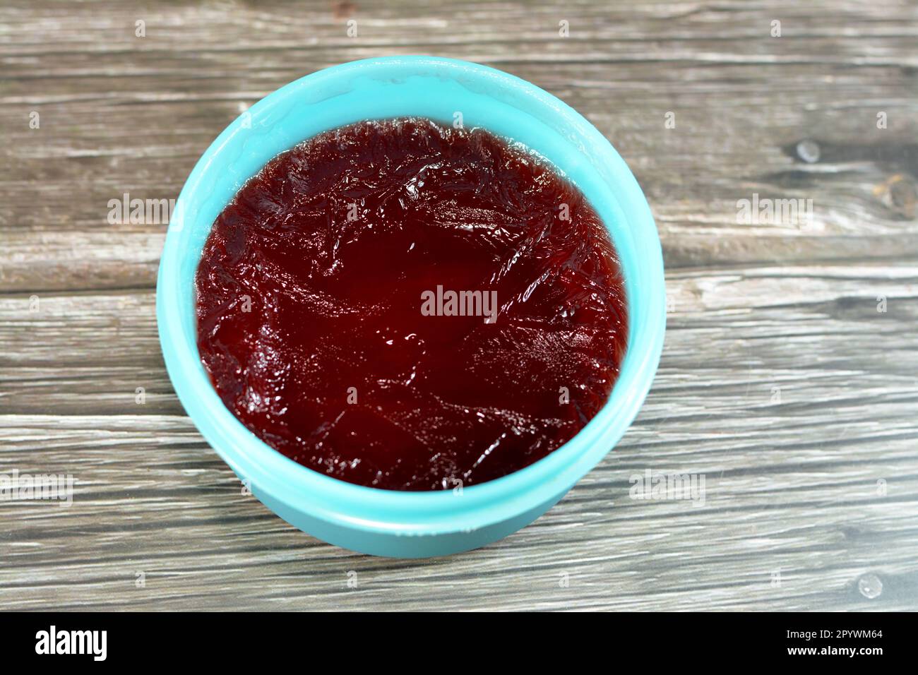 A close up of a delicious sweet red jelly pudding strawberry flavored ...