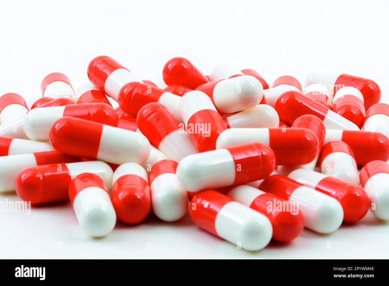 Several red and white pills of medicine on white background with free ...