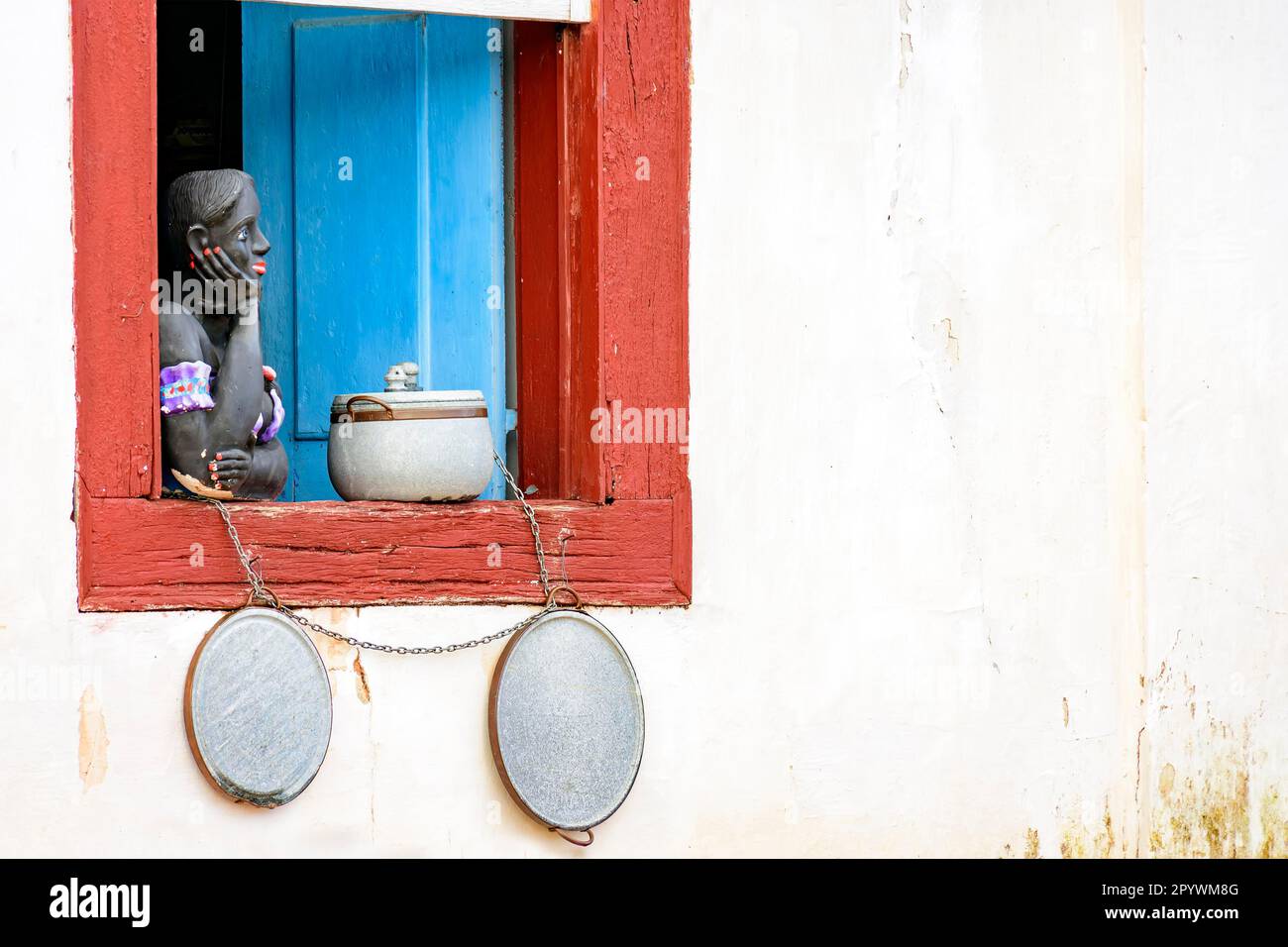 Window decorated with flowers and objects in the historic city of ...