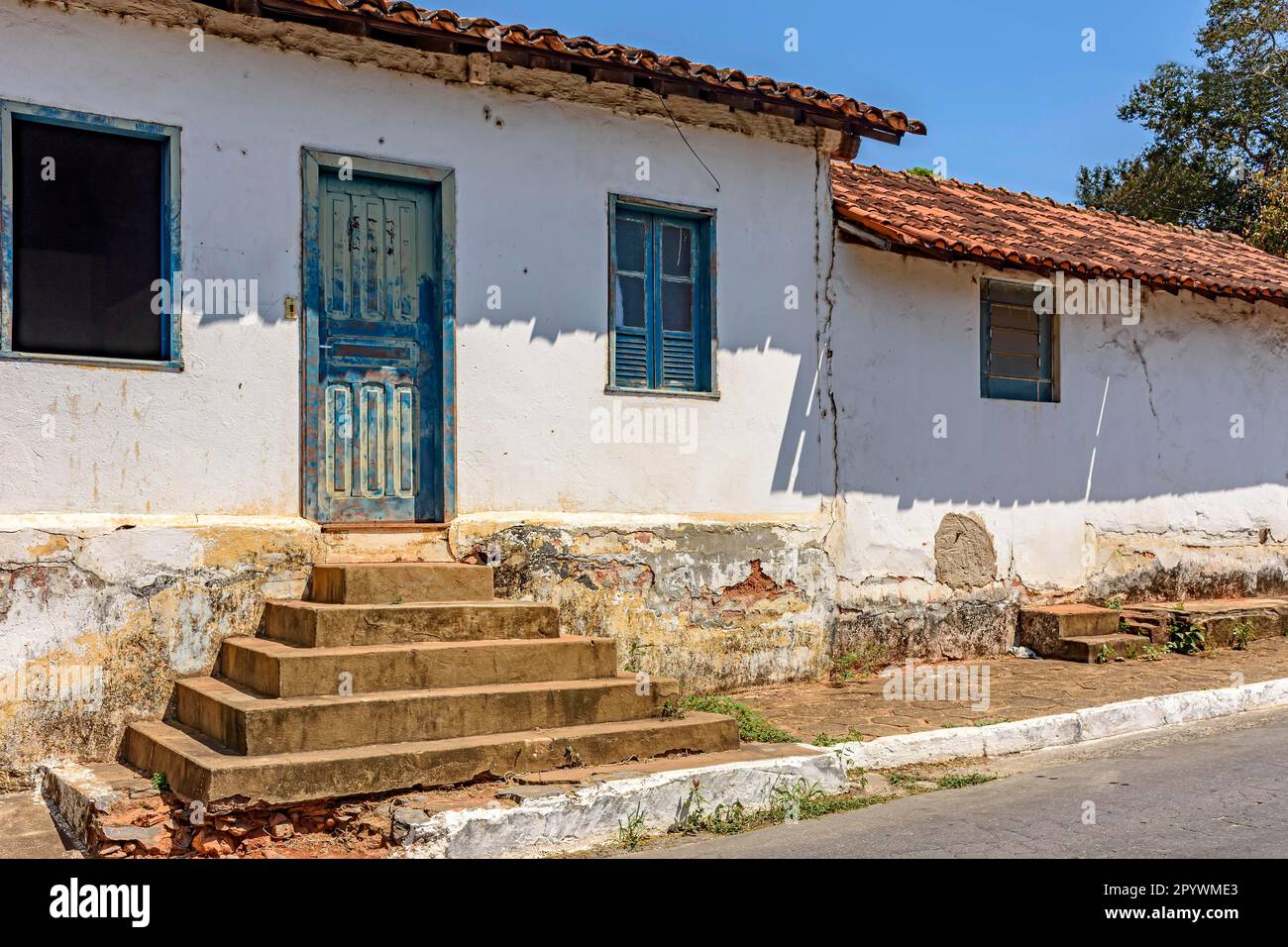 Old weathered house with potholed walls used by poor populations in the ...