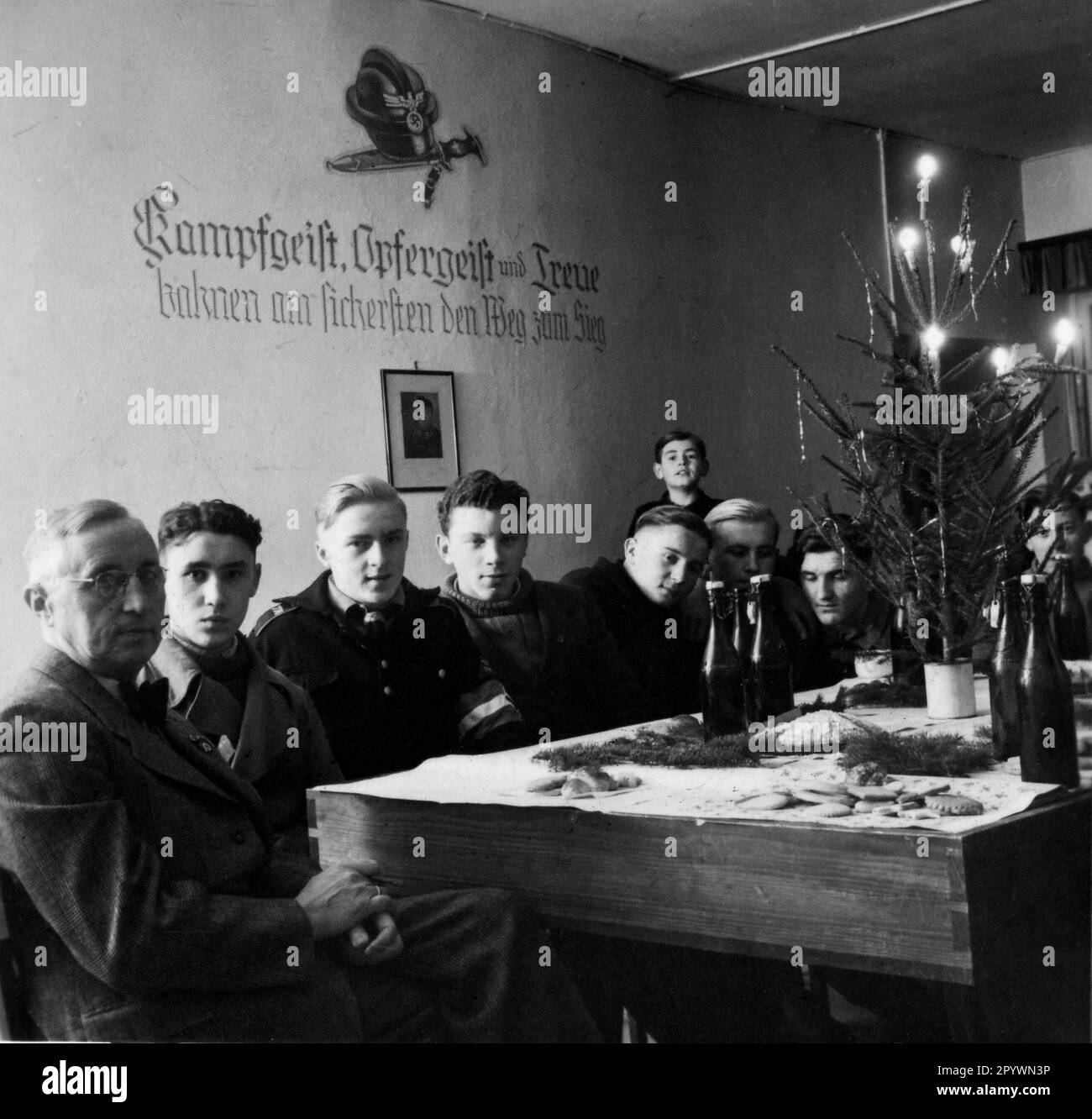 "Germany 1943, Hitler Youth boys sitting next to a Christmas tree ...
