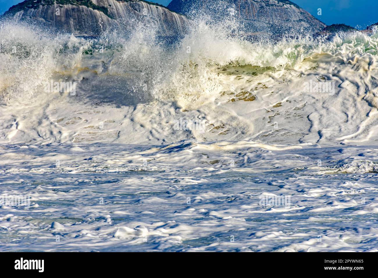 Beautiful and strong sea wave on the beach with water drops and foam ...