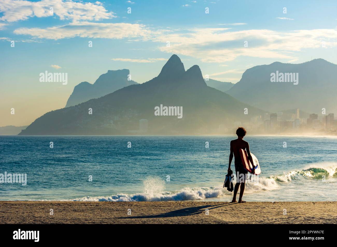Boy with his bodyboard looking at the sea from Ipanema beach in Rio de ...