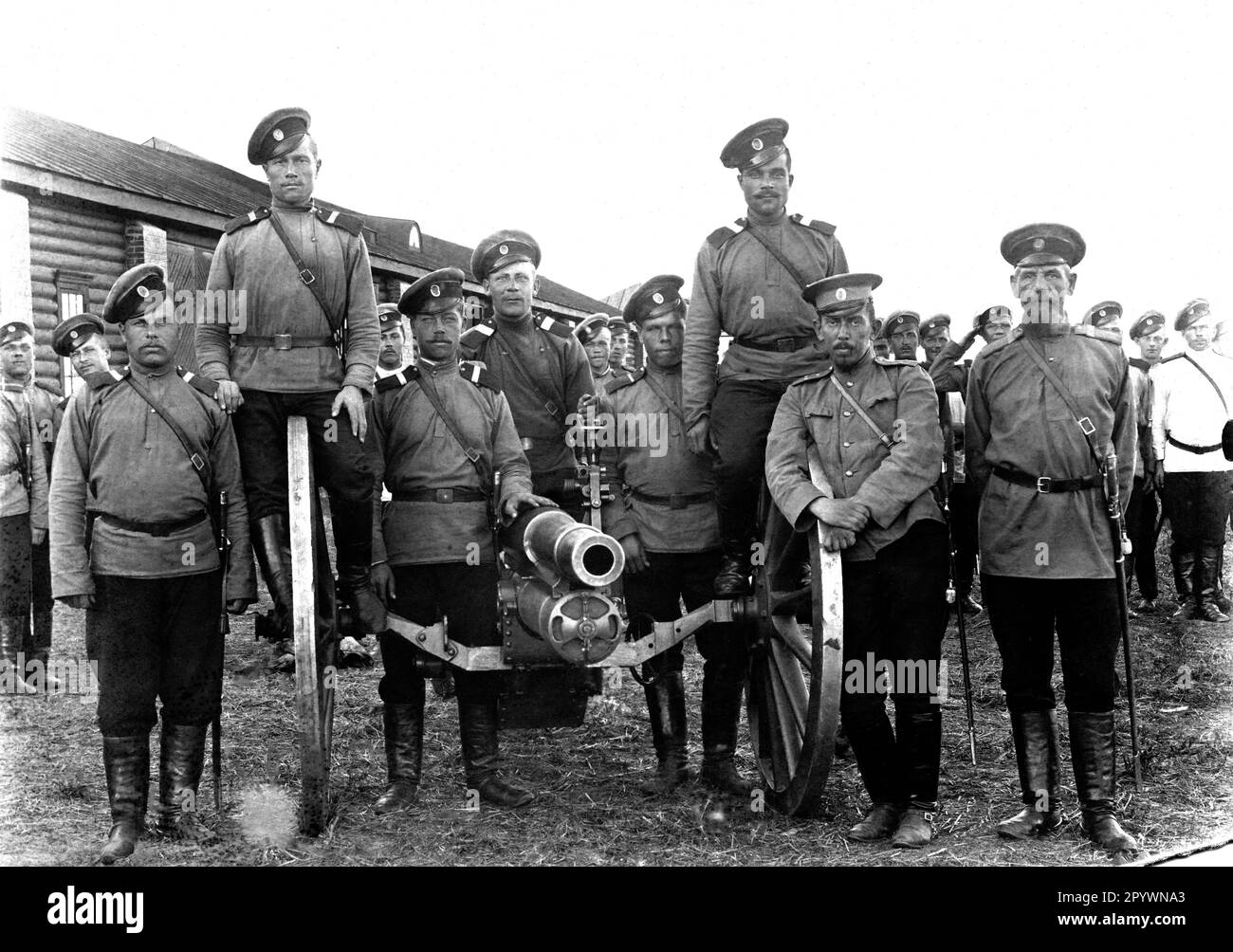 Cannoneers of the Tsarist army pose next to a cannon. [automated ...