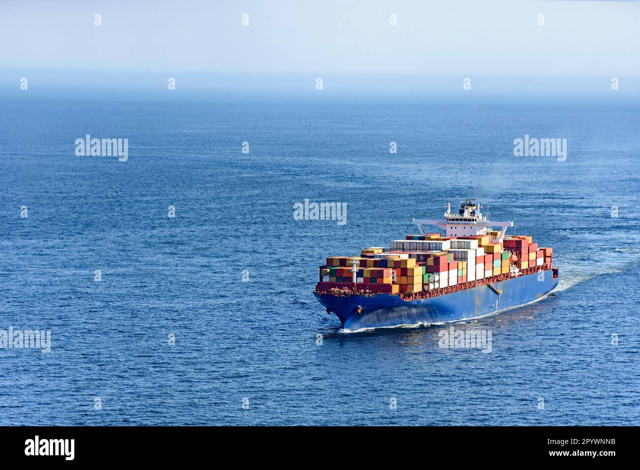 Cargo ship carrying several containers on the waters of the sea of rio ...
