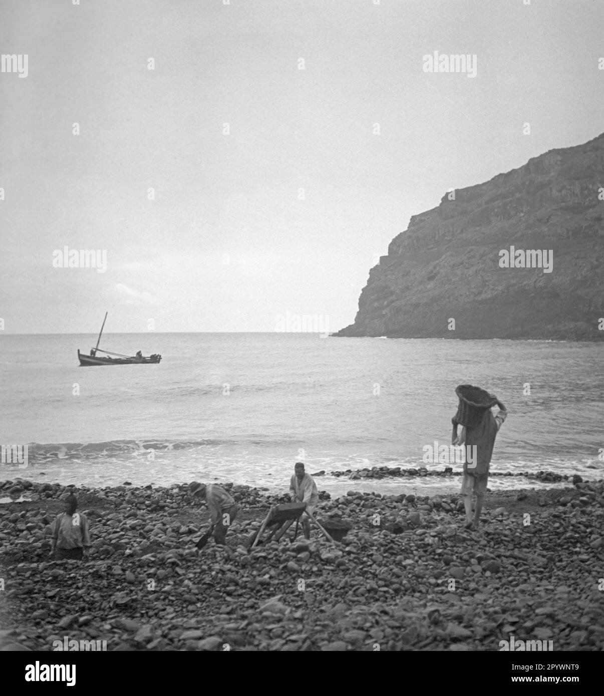 Men work on the beach of Madeira Stock Photo - Alamy