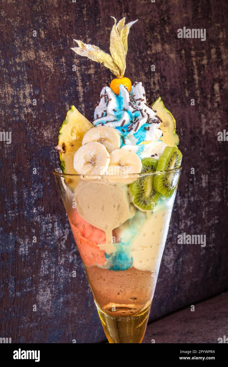 Fruit sundae on brown background Stock Photo - Alamy