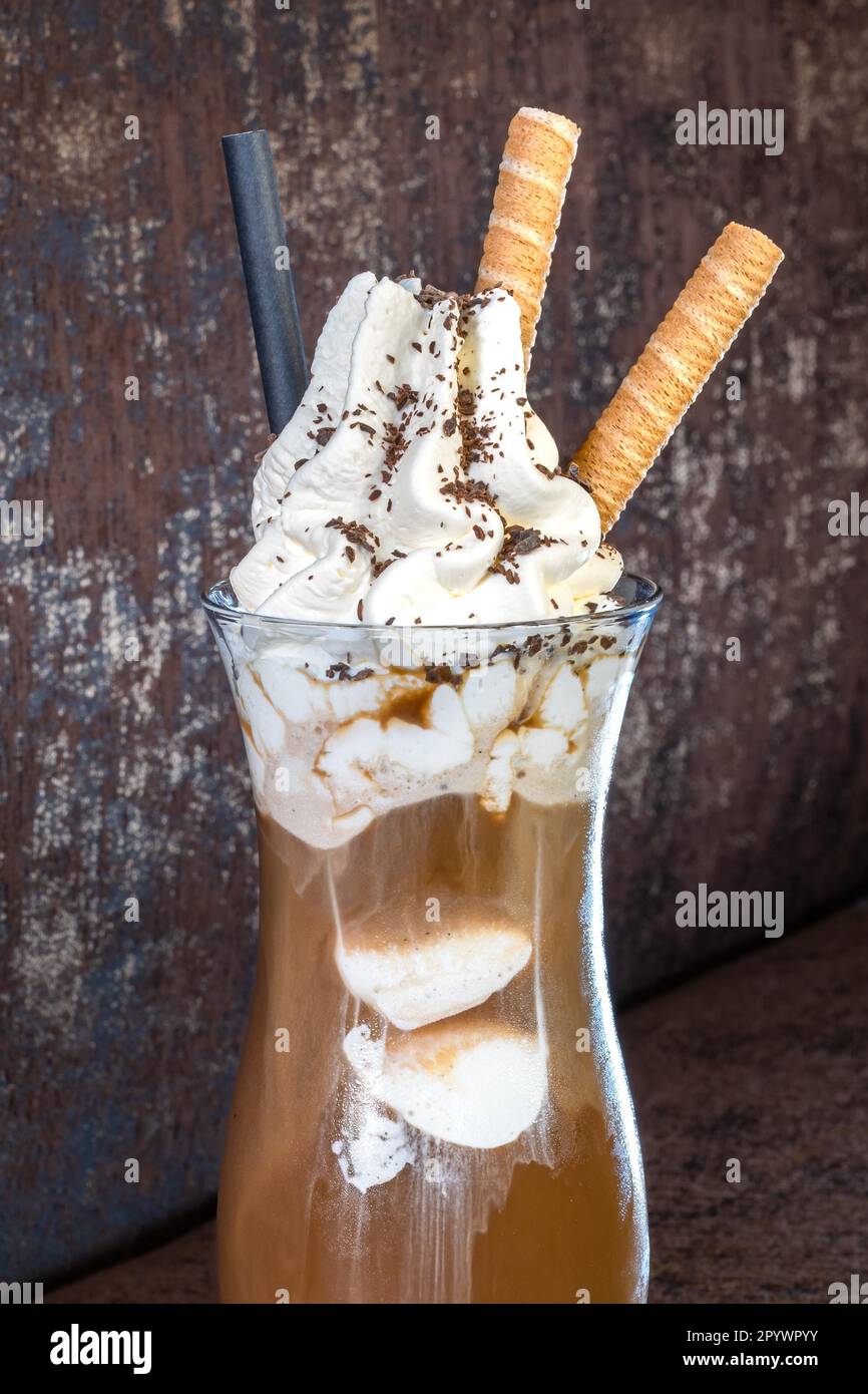 Ice cream cafe with cream in glass on brown background Stock Photo - Alamy