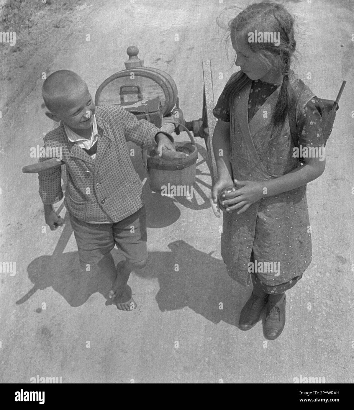 Children carry milk in a wooden barrel on a cart Stock Photo - Alamy